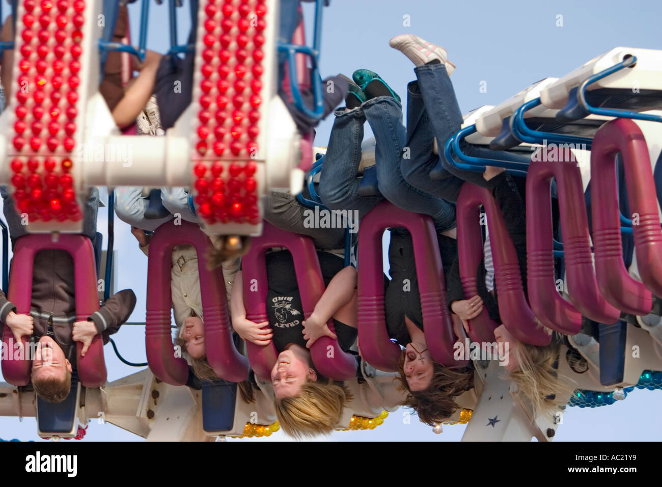 Kids upside down on rotating scary fairground ride Stock Photo - Alamy