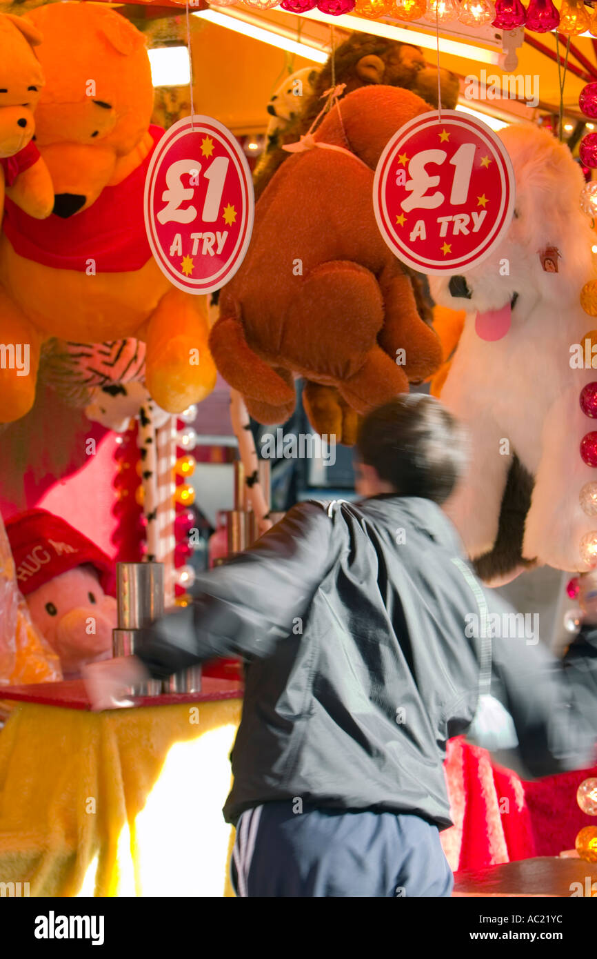 Man trying to knock over a stack of tins fairground sideshow game Stock ...