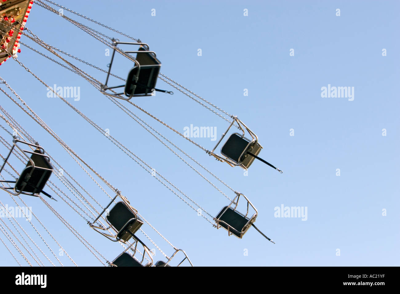 Spinning empty merrygoround carousel chairs Stock Photo - Alamy
