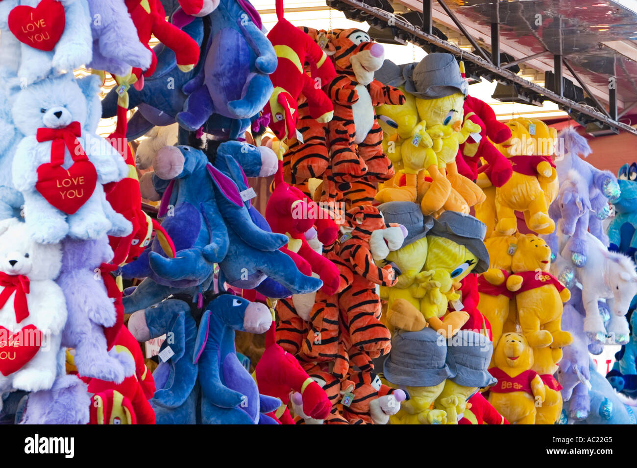 Cuddly soft toys on display at funfair game booth Stock Photo - Alamy