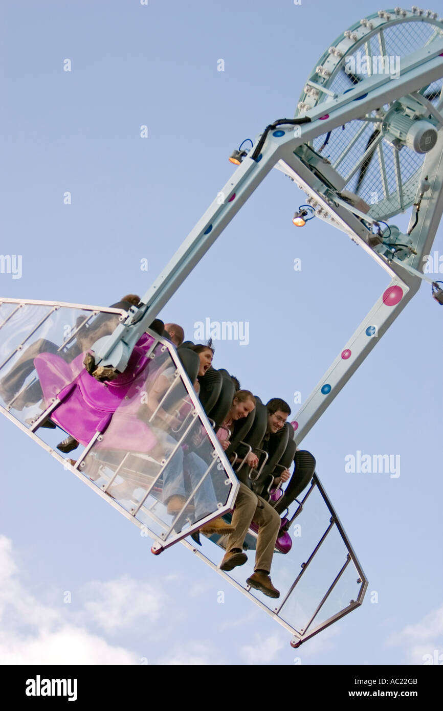 Young people on rotating scary fairground ride Stock Photo - Alamy
