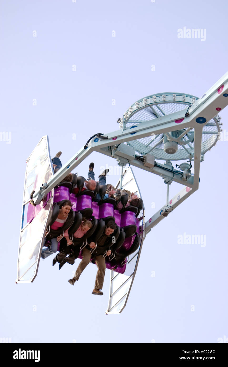 Young people on rotating scary fairground ride Stock Photo - Alamy