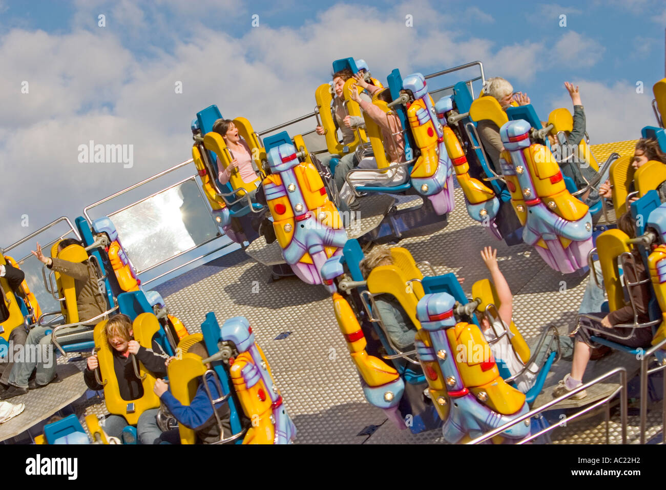 Young people on rotating scary fairground ride Stock Photo - Alamy