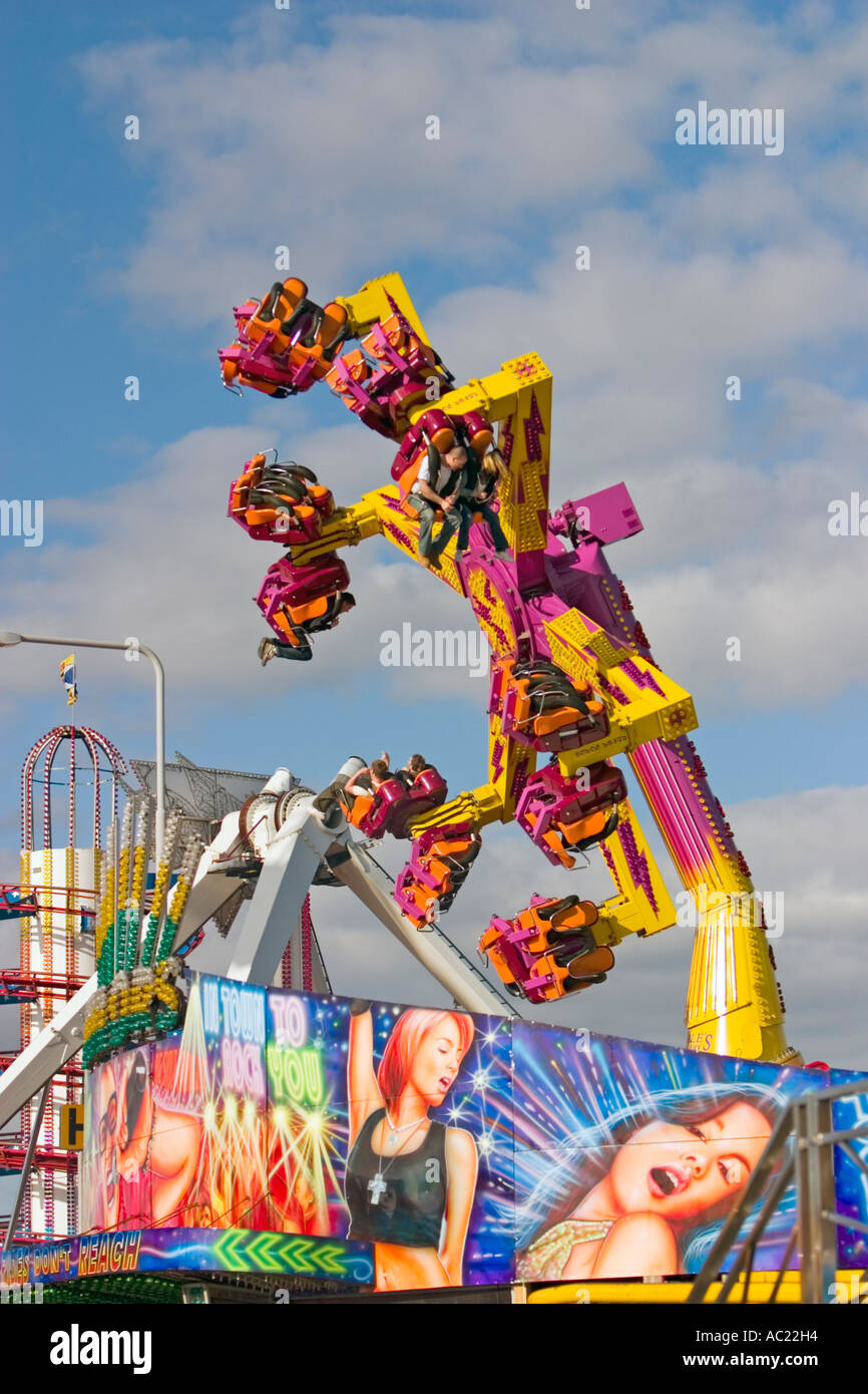 Young people on rotating scary fairground ride Stock Photo - Alamy