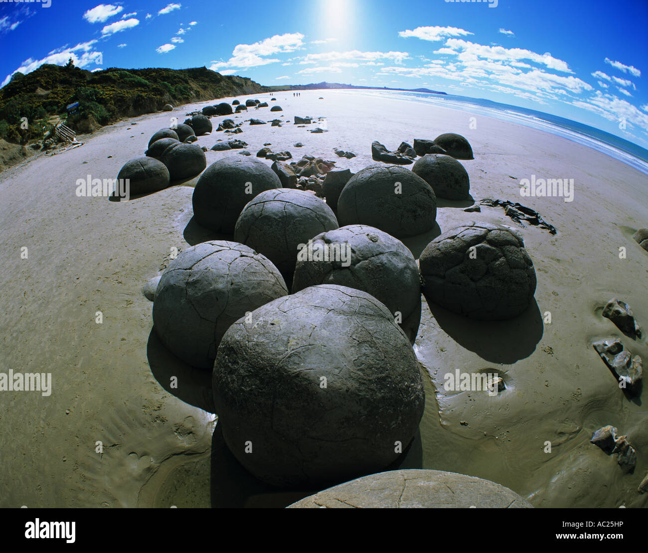 Black round boulders on beach Stock Photo - Alamy