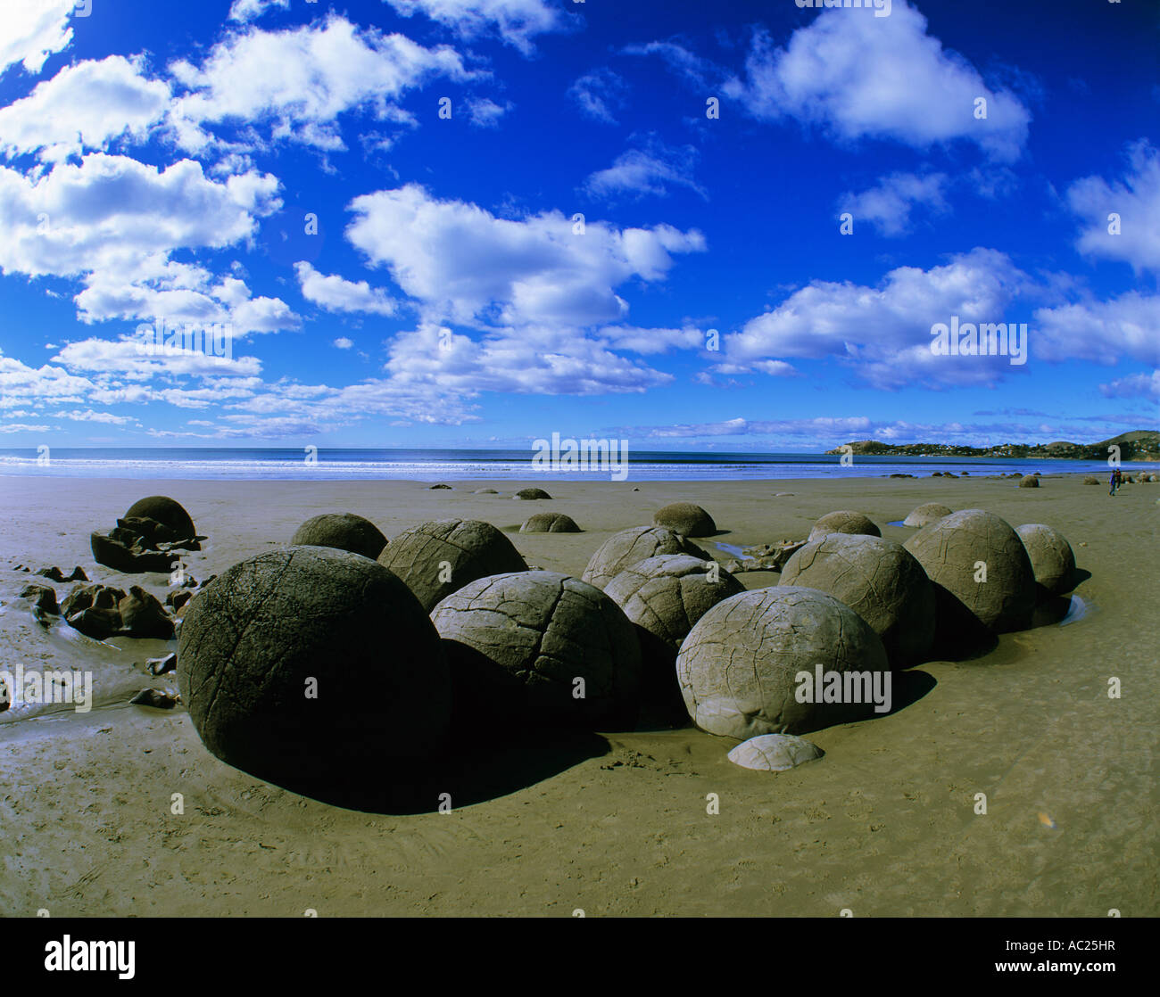 Black round boulders on beach Stock Photo - Alamy