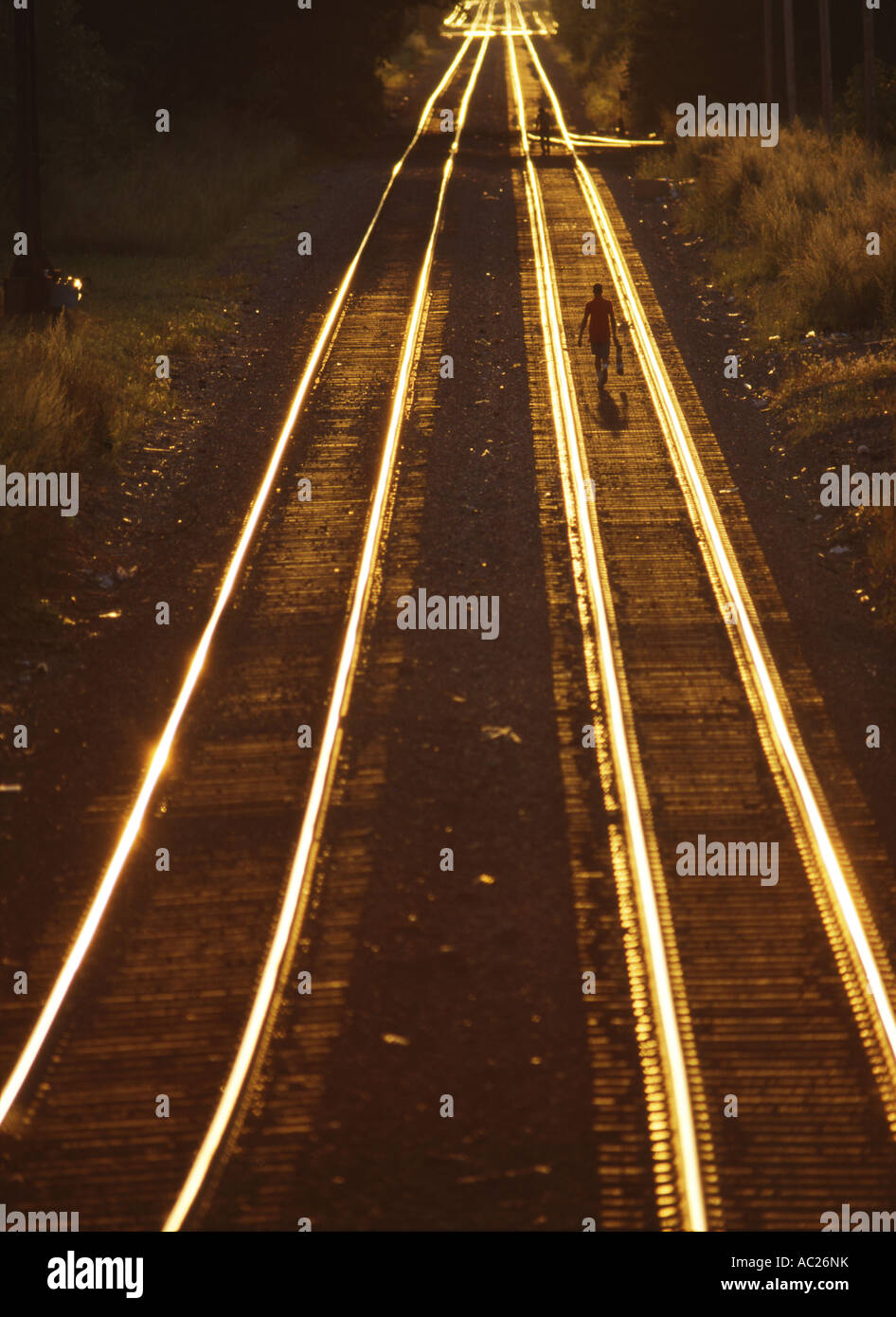 Two people walking on railroad tracks Stock Photo - Alamy