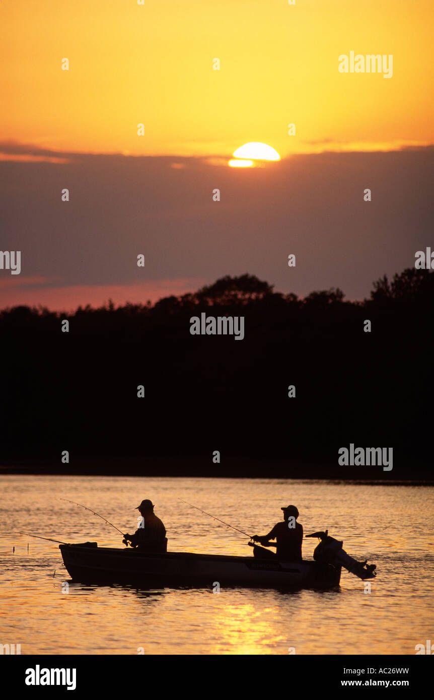 Two people fishing in middle of lake Stock Photo - Alamy
