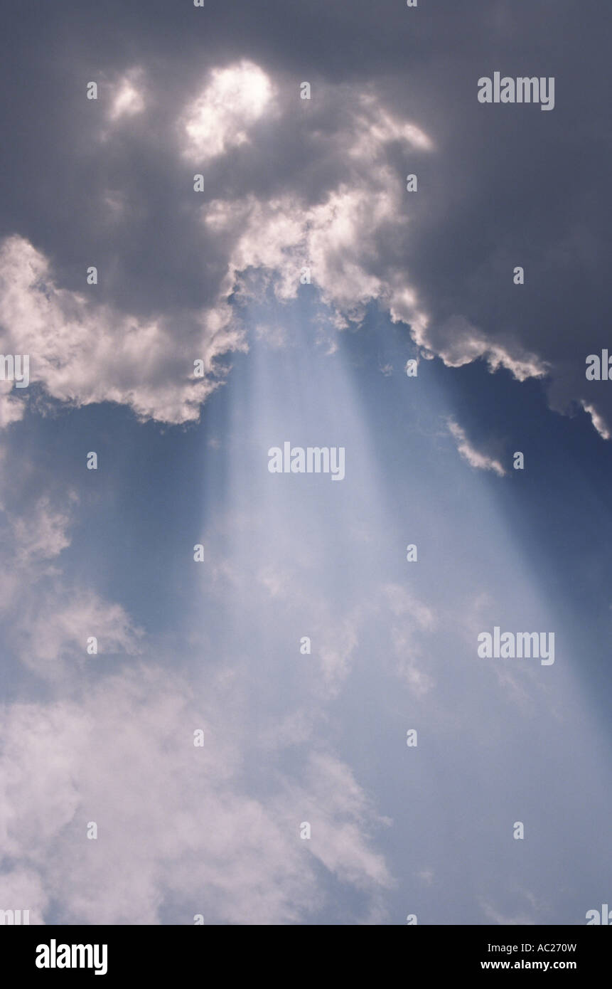 Sunrays going through clouds Stock Photo - Alamy