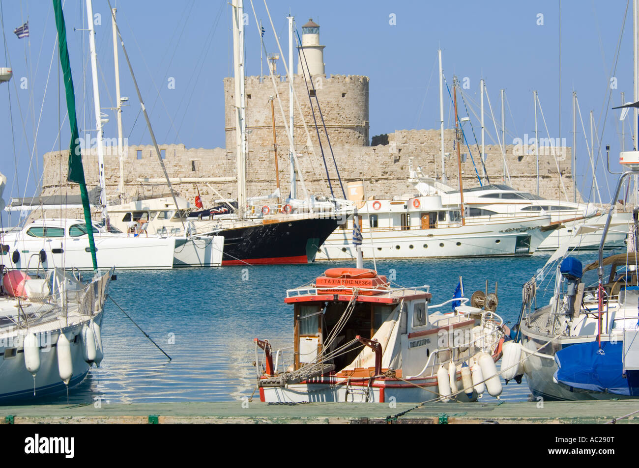 Mandraki Harbour on Rhodes island with yachts, motor boats and fishing ...