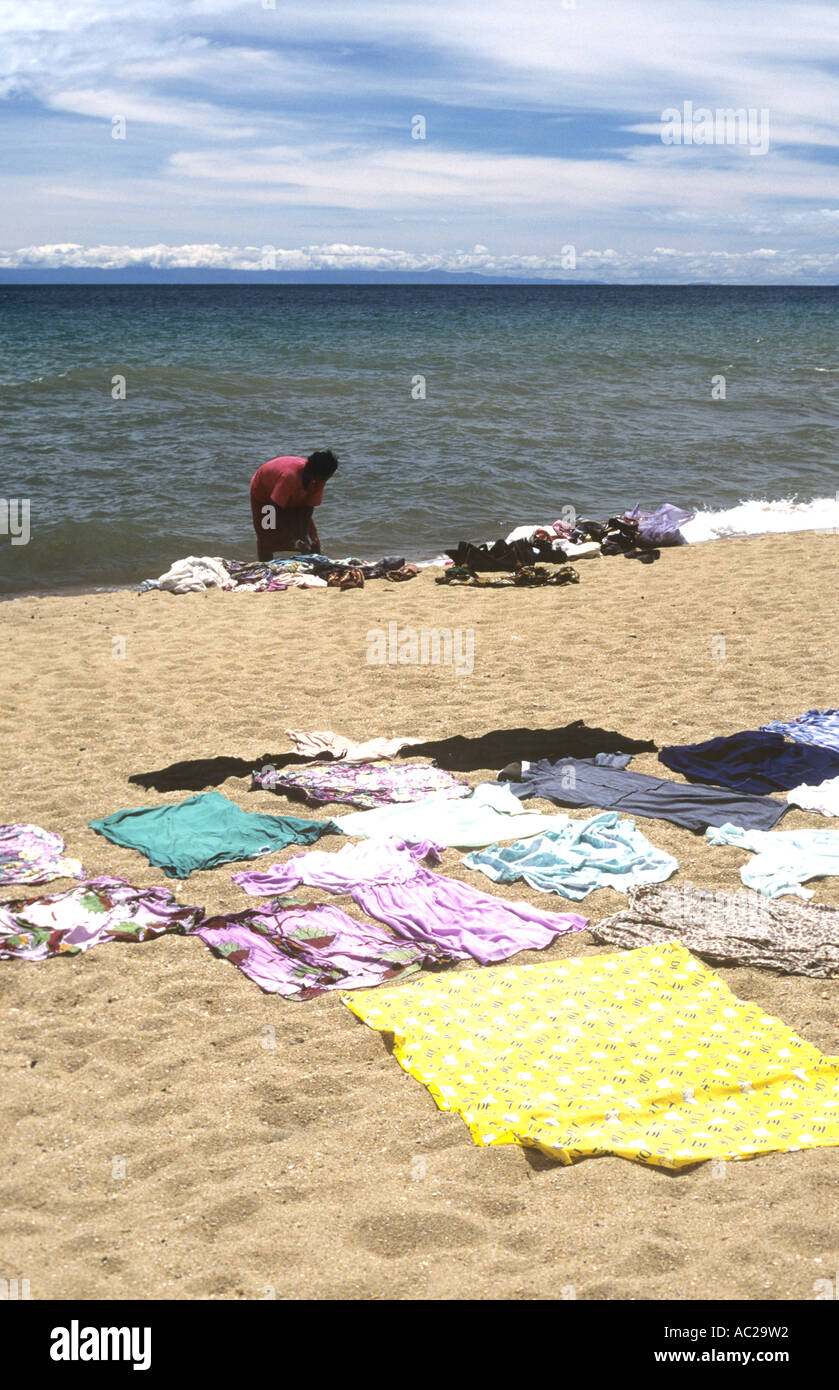 Local woman drying clothes on the beach at Chikale Bay, Lake Malawi ...