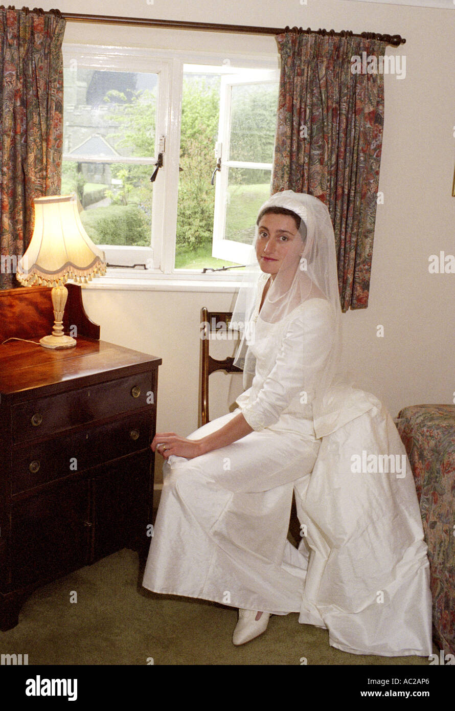 Bride sitting on a chair before her wedding in her bedroom Stock Photo ...