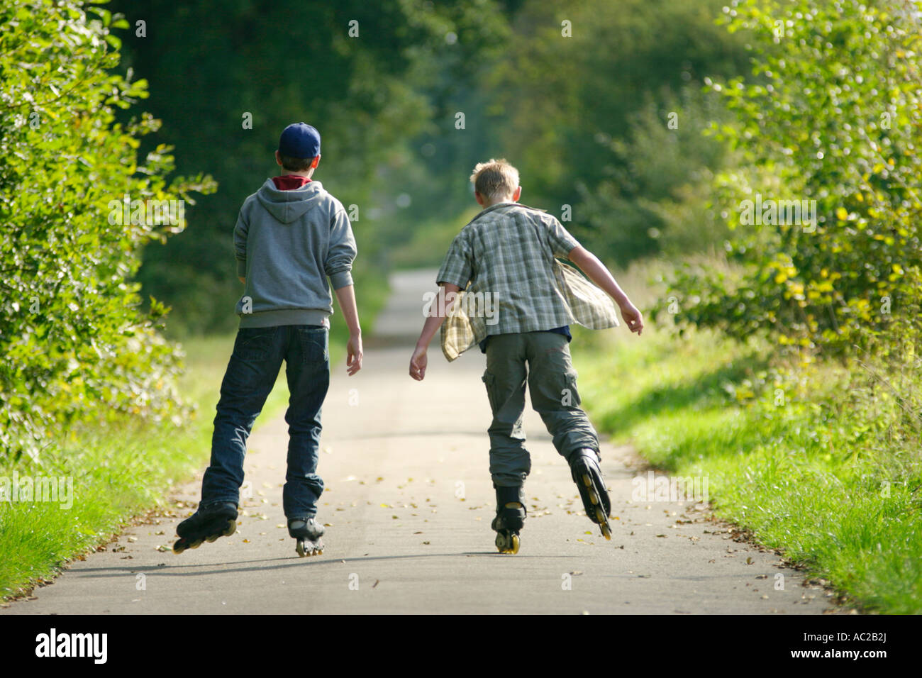 two young boys skating together Stock Photo - Alamy