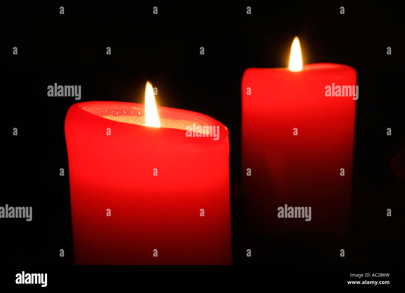 two burning red candles Stock Photo - Alamy