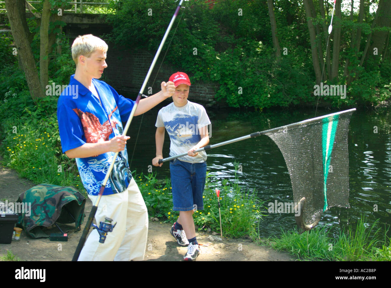 young boys are happy because they have caught a fish Stock Photo - Alamy