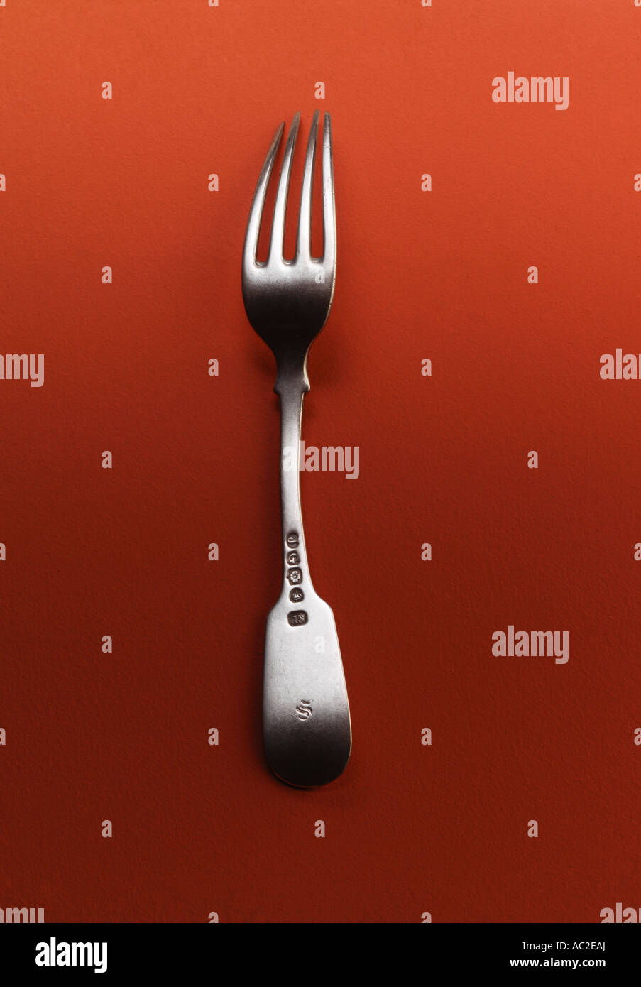 FORK ON RED BACKGROUND Stock Photo - Alamy