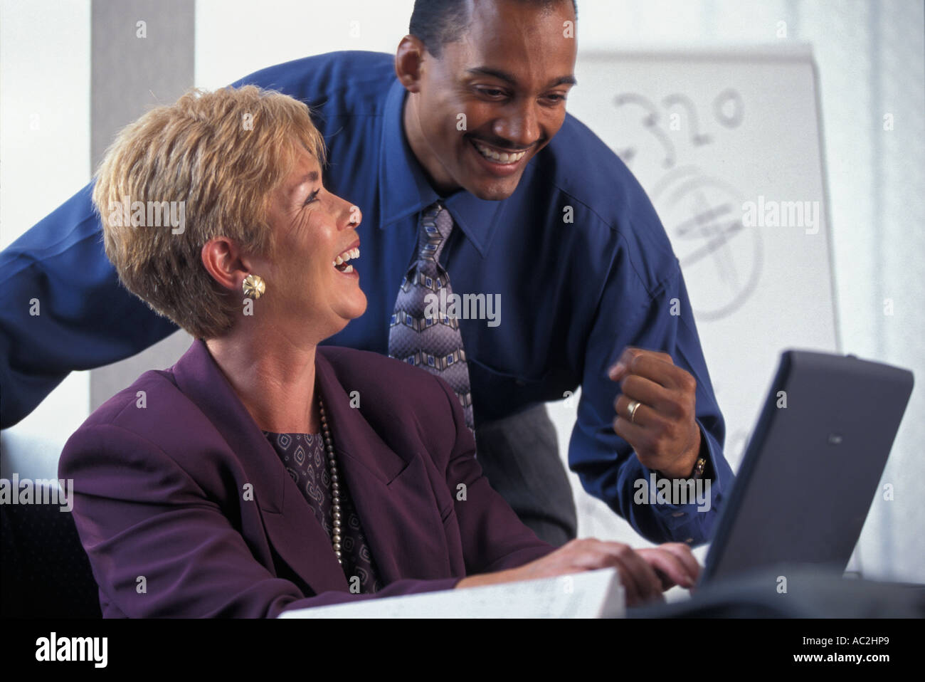 Co-workers celebrate success Stock Photo - Alamy