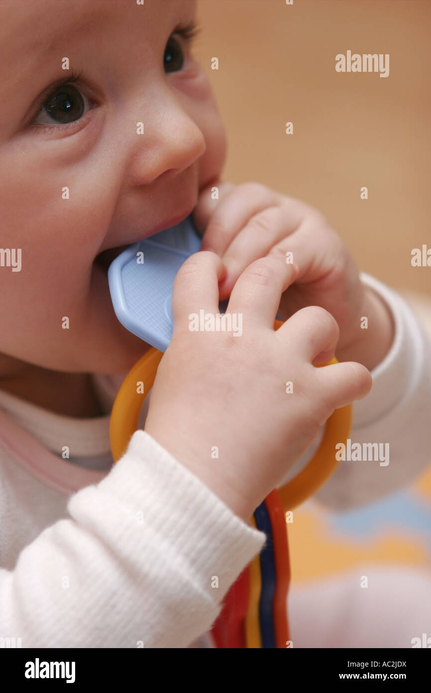 Baby hand holding rattle toy detail hi-res stock photography and images ...