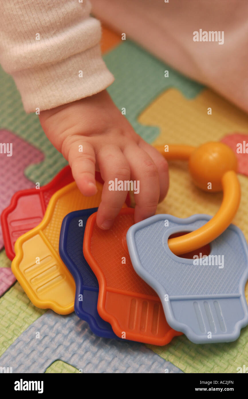 Baby hand holding rattle toy detail hi-res stock photography and images ...
