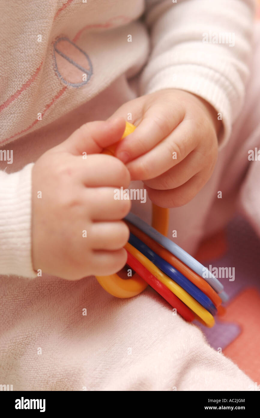 Baby hand holding rattle toy detail hi-res stock photography and images ...