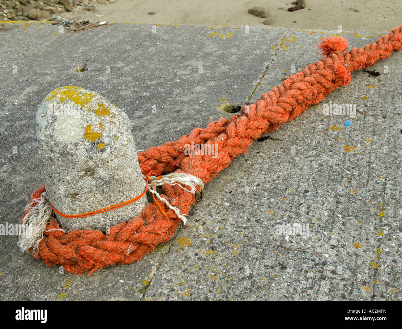 old rope for fixing a boat on a beach at the Atlantic coast in Brittany ...