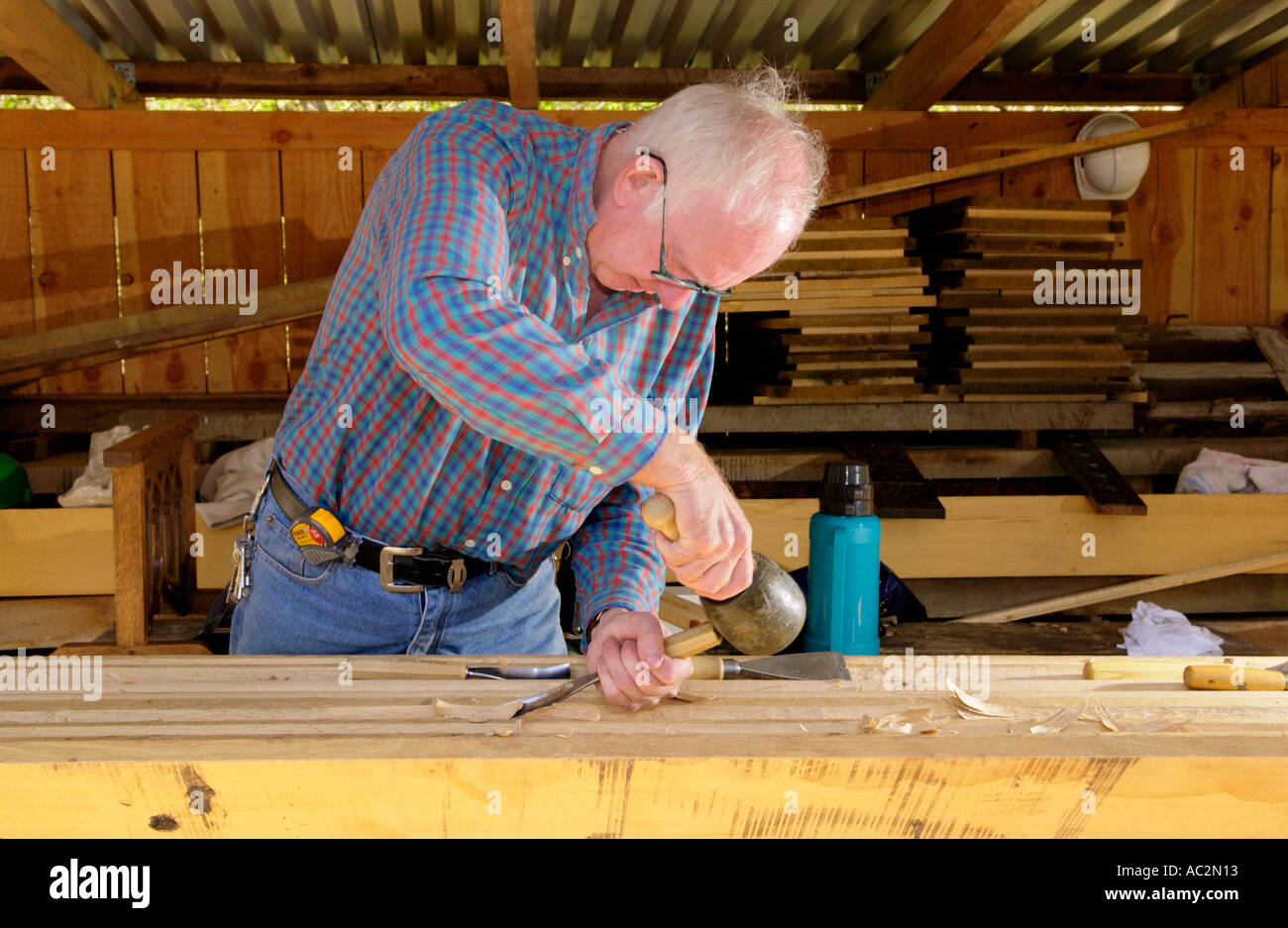 Wood carver working on a rood screen for the reconstruction of the 13th ...