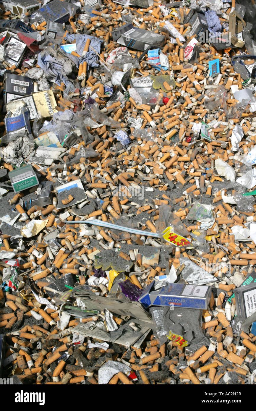 Discarded cigarette butts and packaging Stock Photo - Alamy