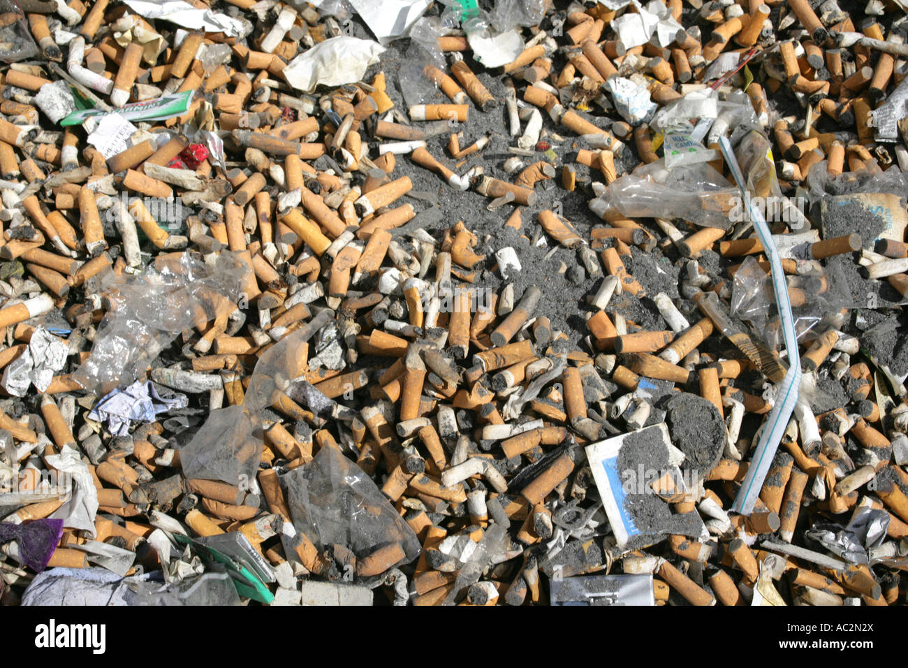 Discarded cigarette butts and packaging Stock Photo - Alamy