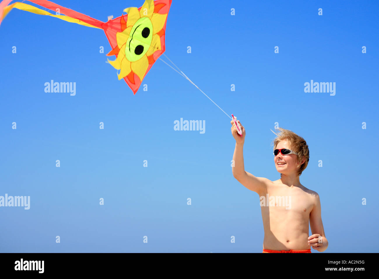 a young boy flying a kite Stock Photo - Alamy