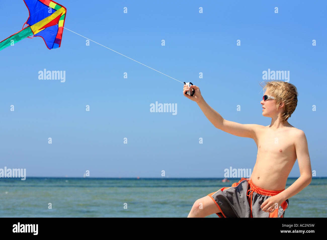 a young boy flying a kite Stock Photo - Alamy