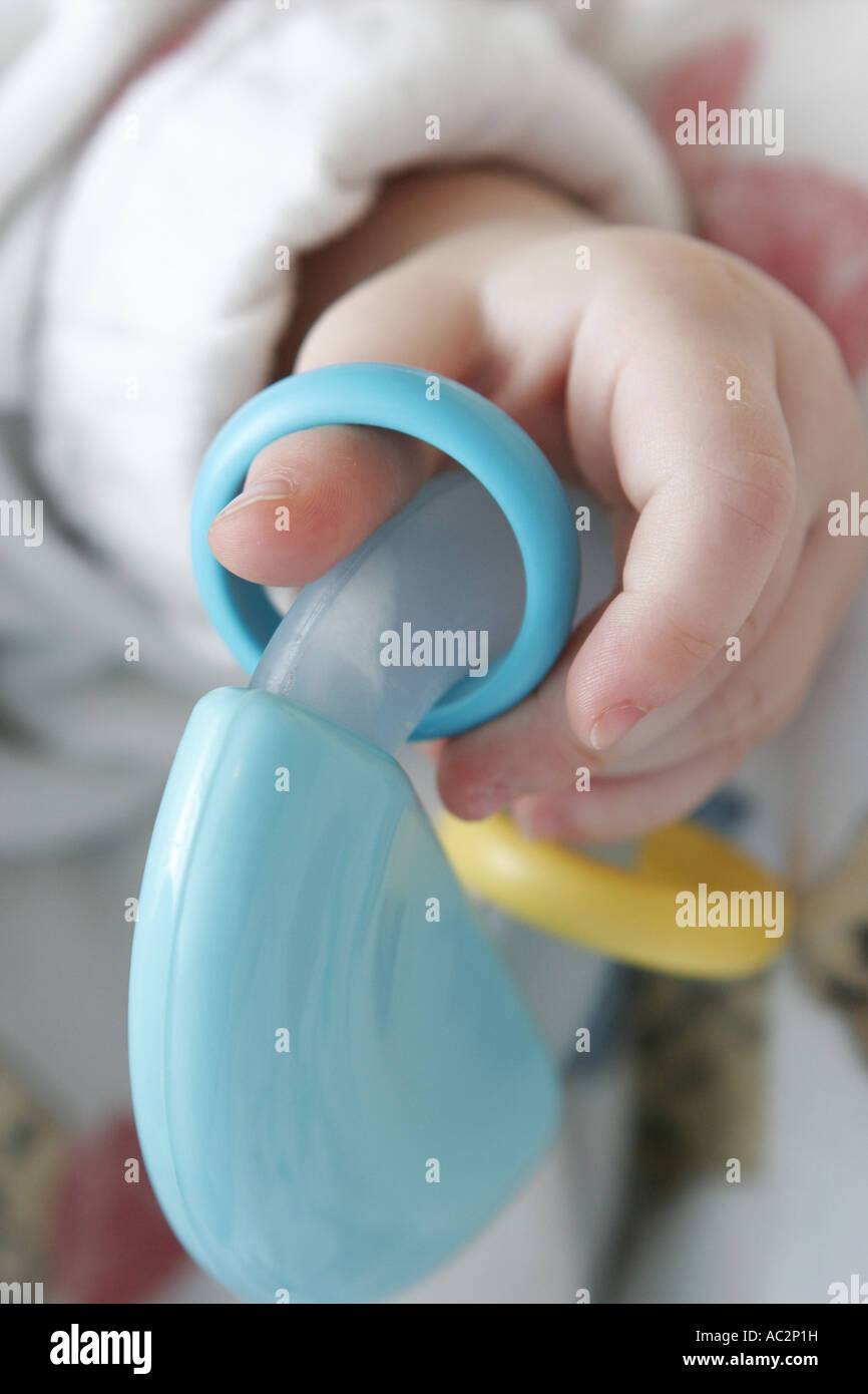 Baby hand holding rattle toy detail hi-res stock photography and images ...