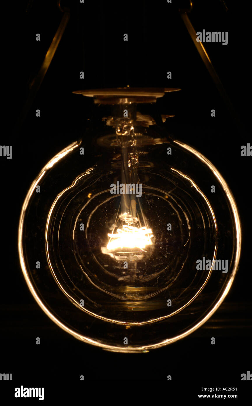 Three electric lightbulbs in a row lighting up the dark Stock Photo - Alamy