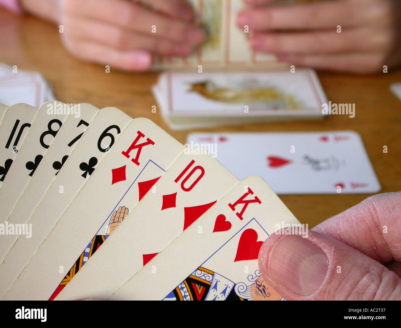 Playing a Card from the hand Stock Photo - Alamy