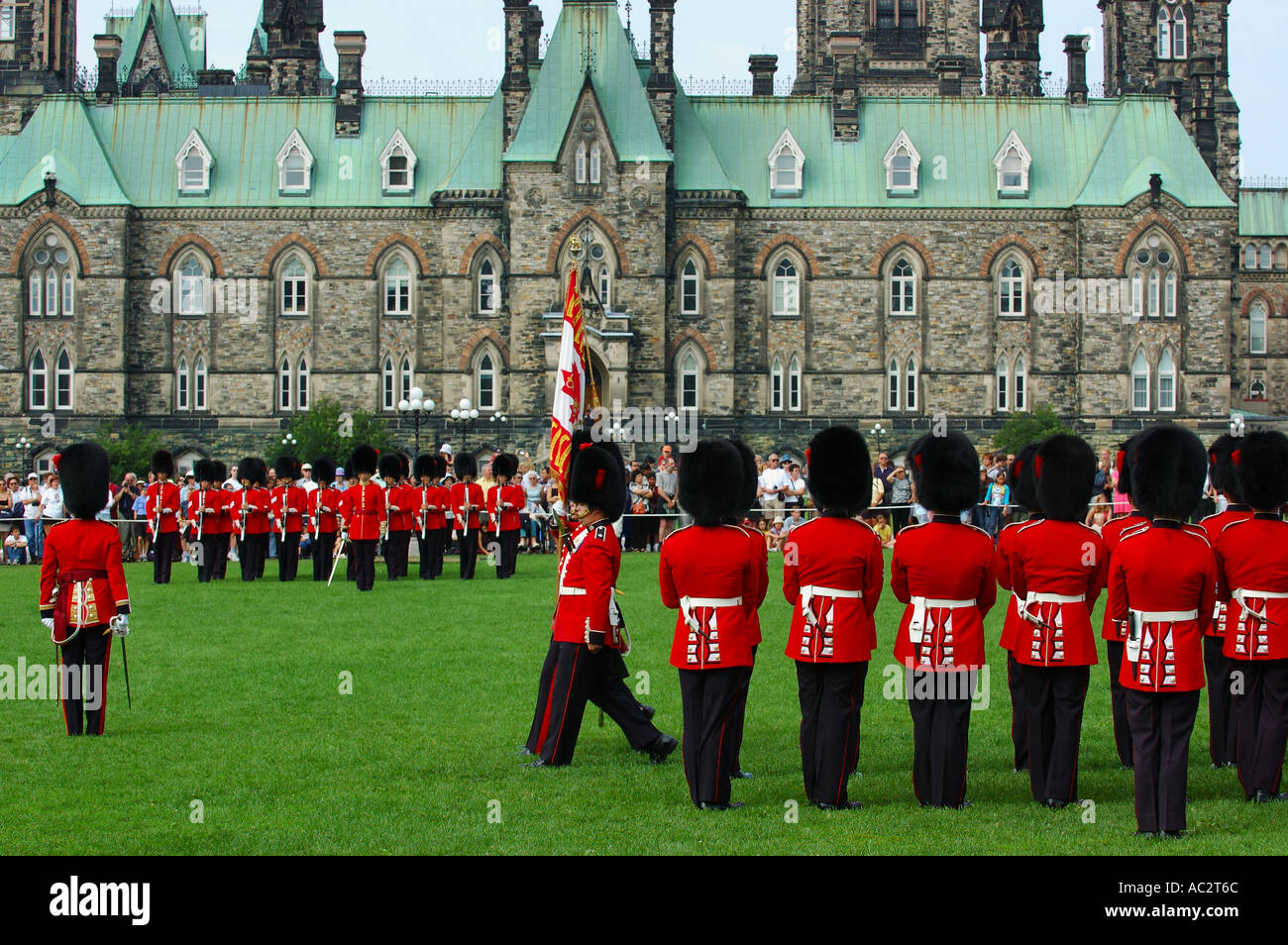 Changing of the Guards in red uniform on grass on Parliament Hill ...