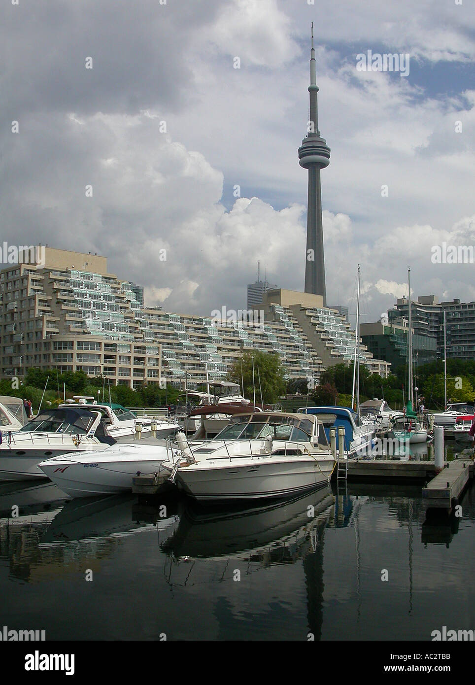 CN tower reflected on harbour water with docked boats in marina Toronto ...