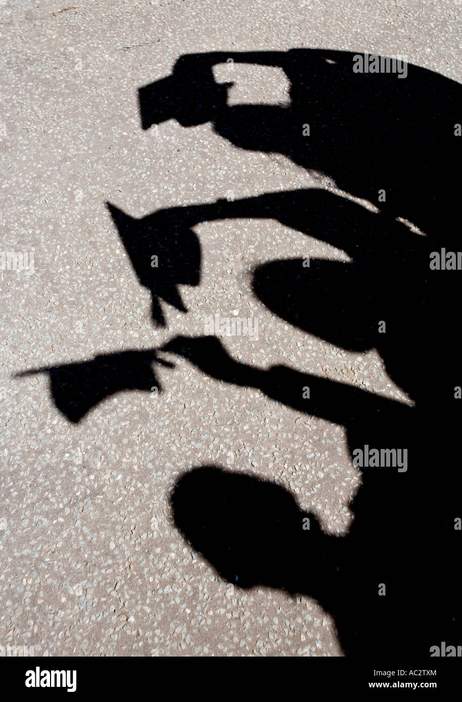 The shadows of three graduates after one of the degree ceremonies at ...