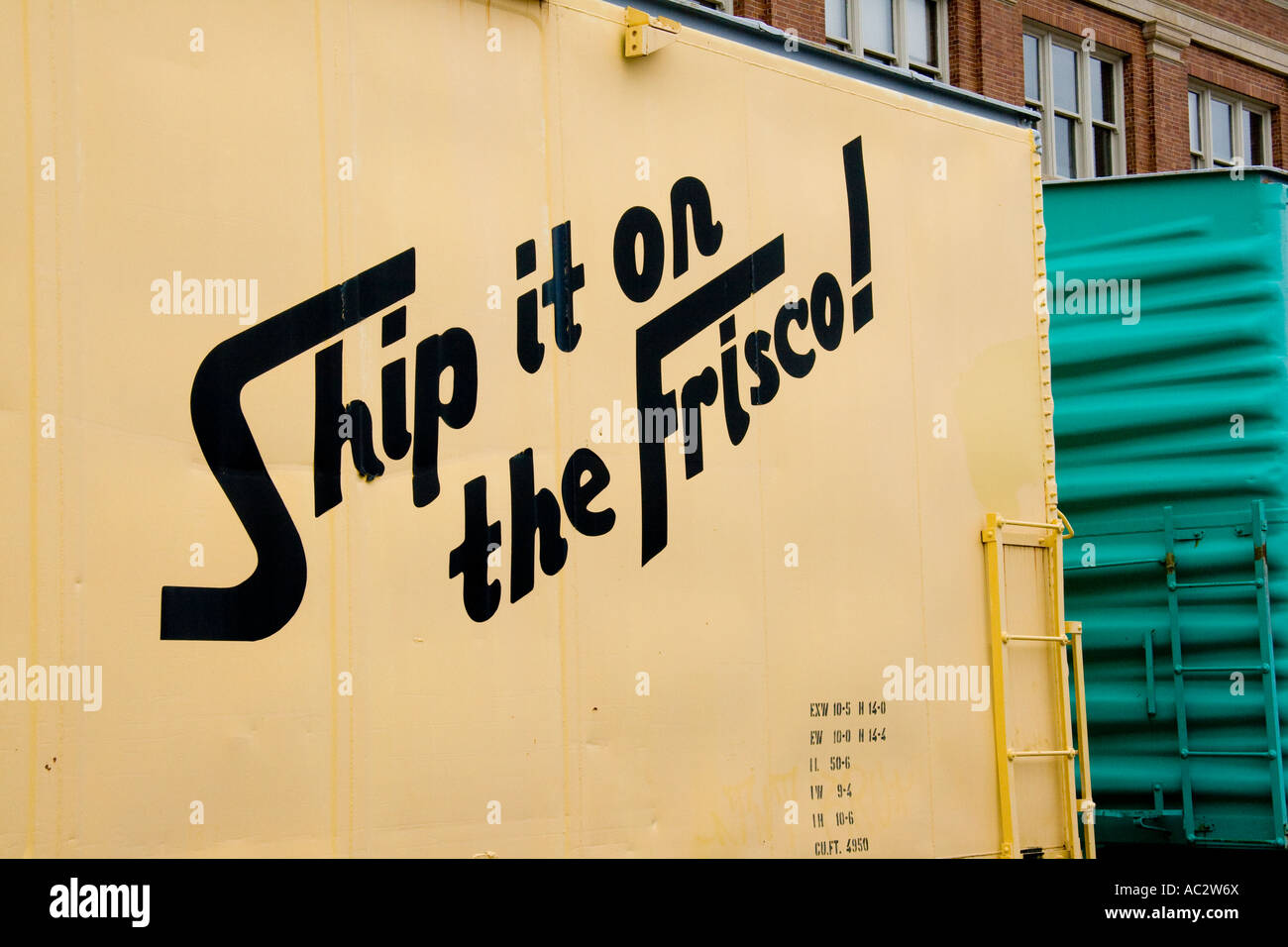 Yellow painted boxcar of railroad train Stock Photo - Alamy