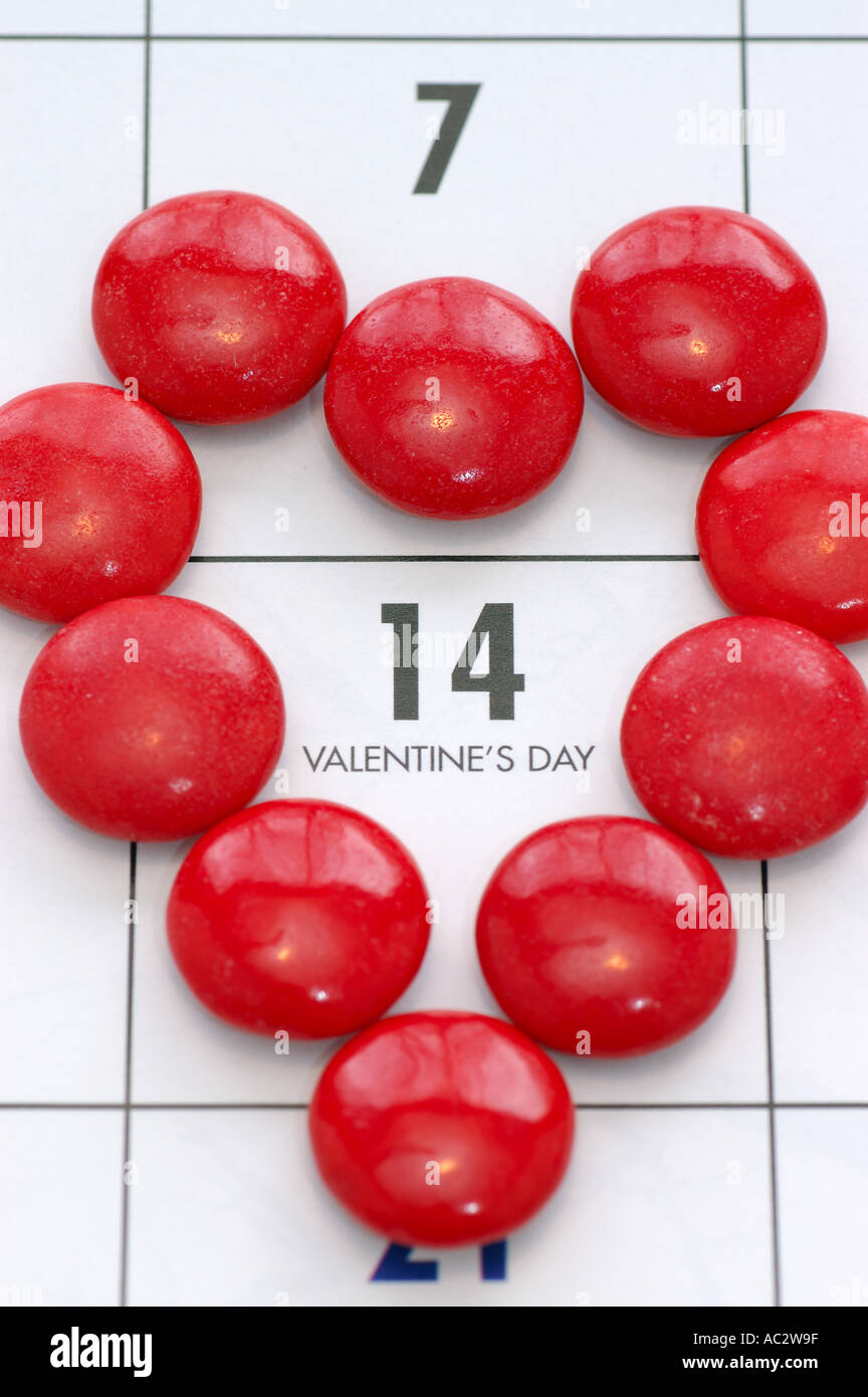 February 14th calendar with red candies in heart shape Stock Photo - Alamy