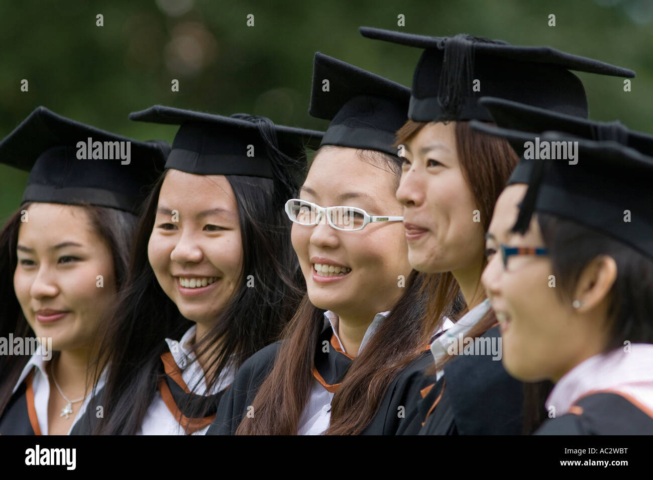 A row of young ladies pose for a photograph after one of the degree ...