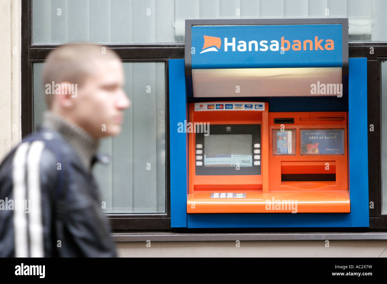 A pedestrian passes an Hansa Banka branch office in Riga, Latvia Stock ...