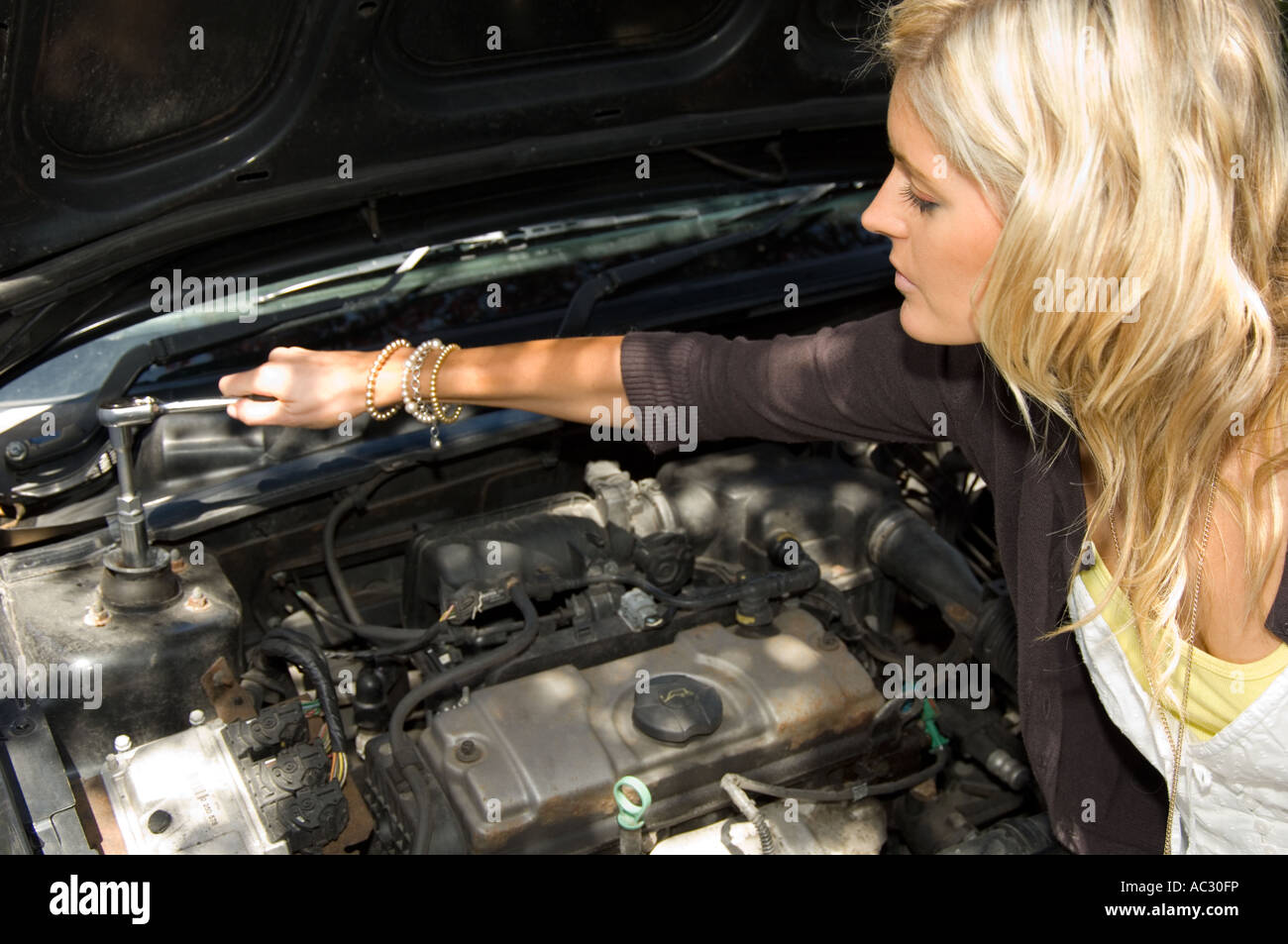 woman working on a car engine with a socket wrench Stock Photo - Alamy