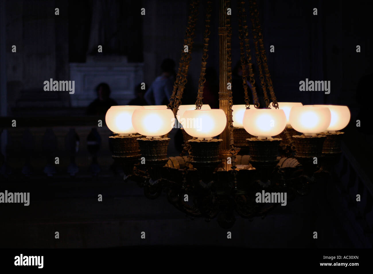 Dimly lit chandelier glowing in the darkness at the Palace of ...