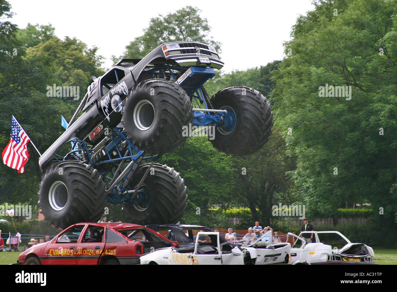 Large black big wheel truck doing demonstration of power by driving at ...