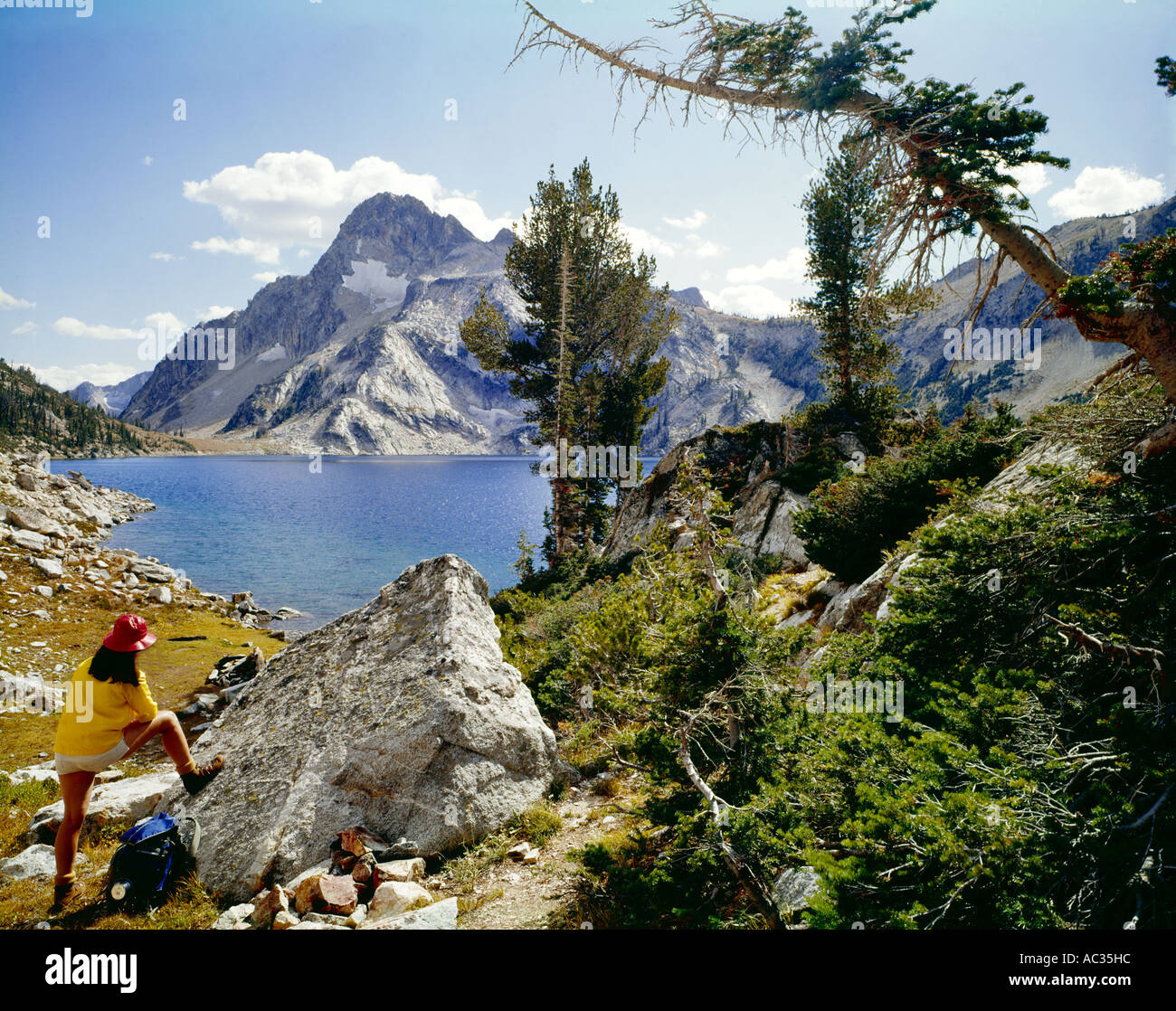 Hiker pauses at Sawtooth Lake to view Mount Reagan in the Sawtooth ...