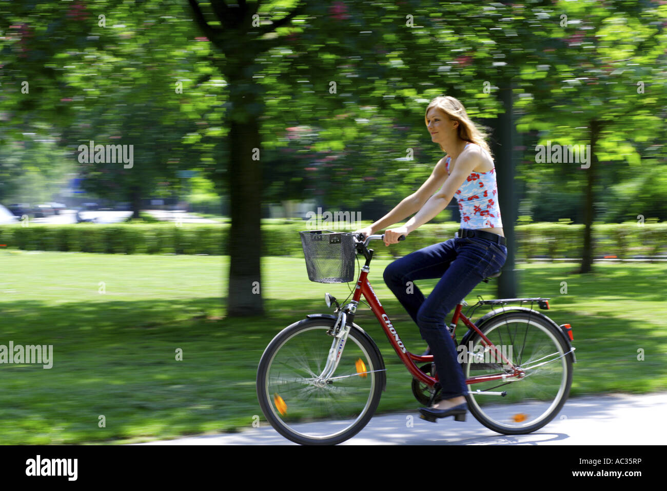 young woman riding bike, Austria Stock Photo - Alamy