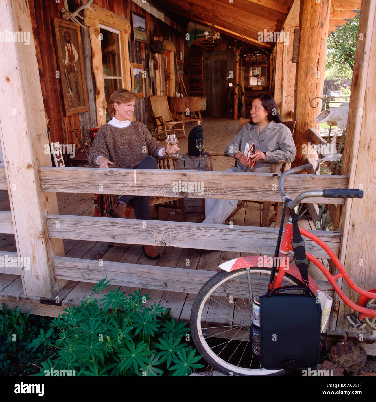 Two Women Relaxing on the Porch Stock Photo - Alamy