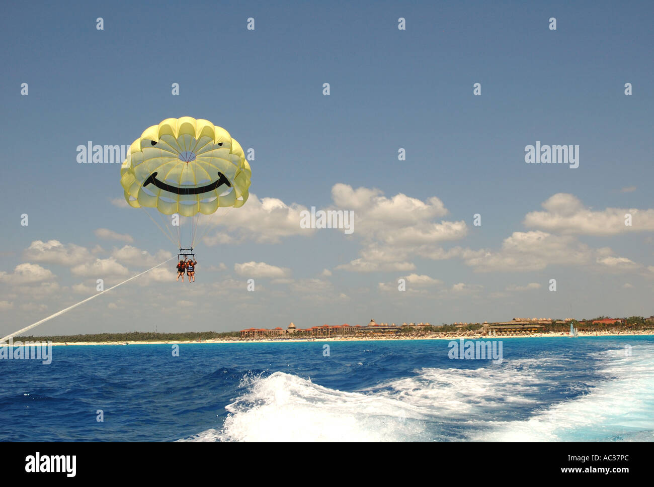 Two women parasail above the blue waters off Playa del Carmen, Mexico ...