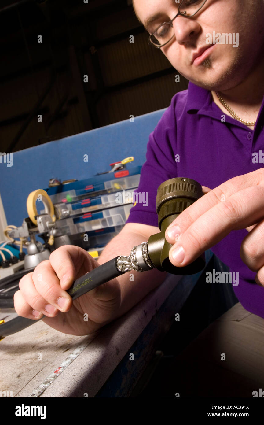 Operator examining heavy duty cable connector Stock Photo - Alamy