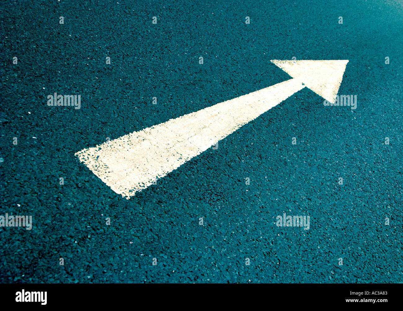 Road marking arrow direction pointing towards the direction of travel ...