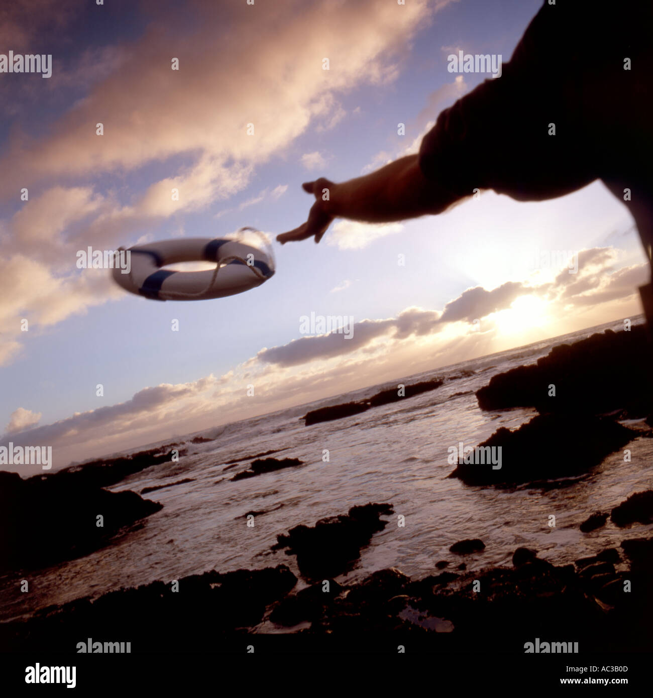 Hand throwing life preserver in ocean Stock Photo - Alamy